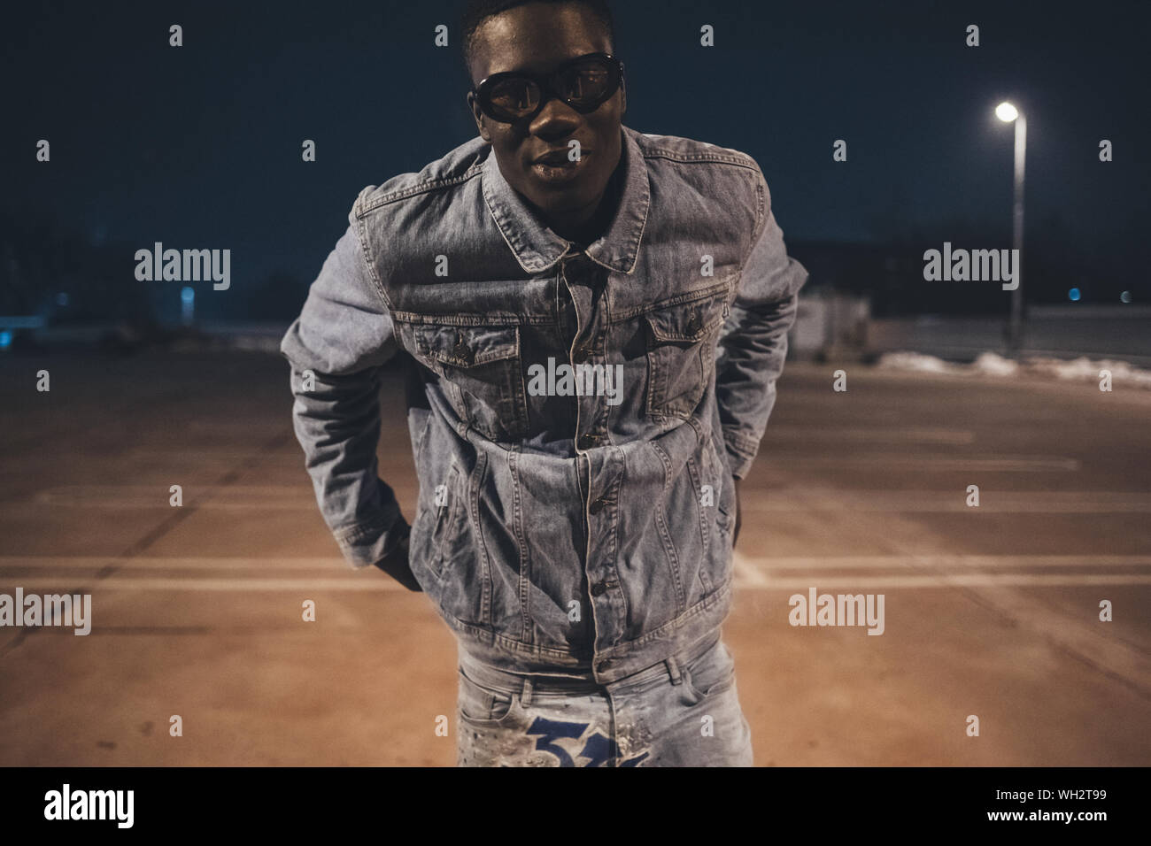 portrait of young black man standing outdoor in parking space – youth ...