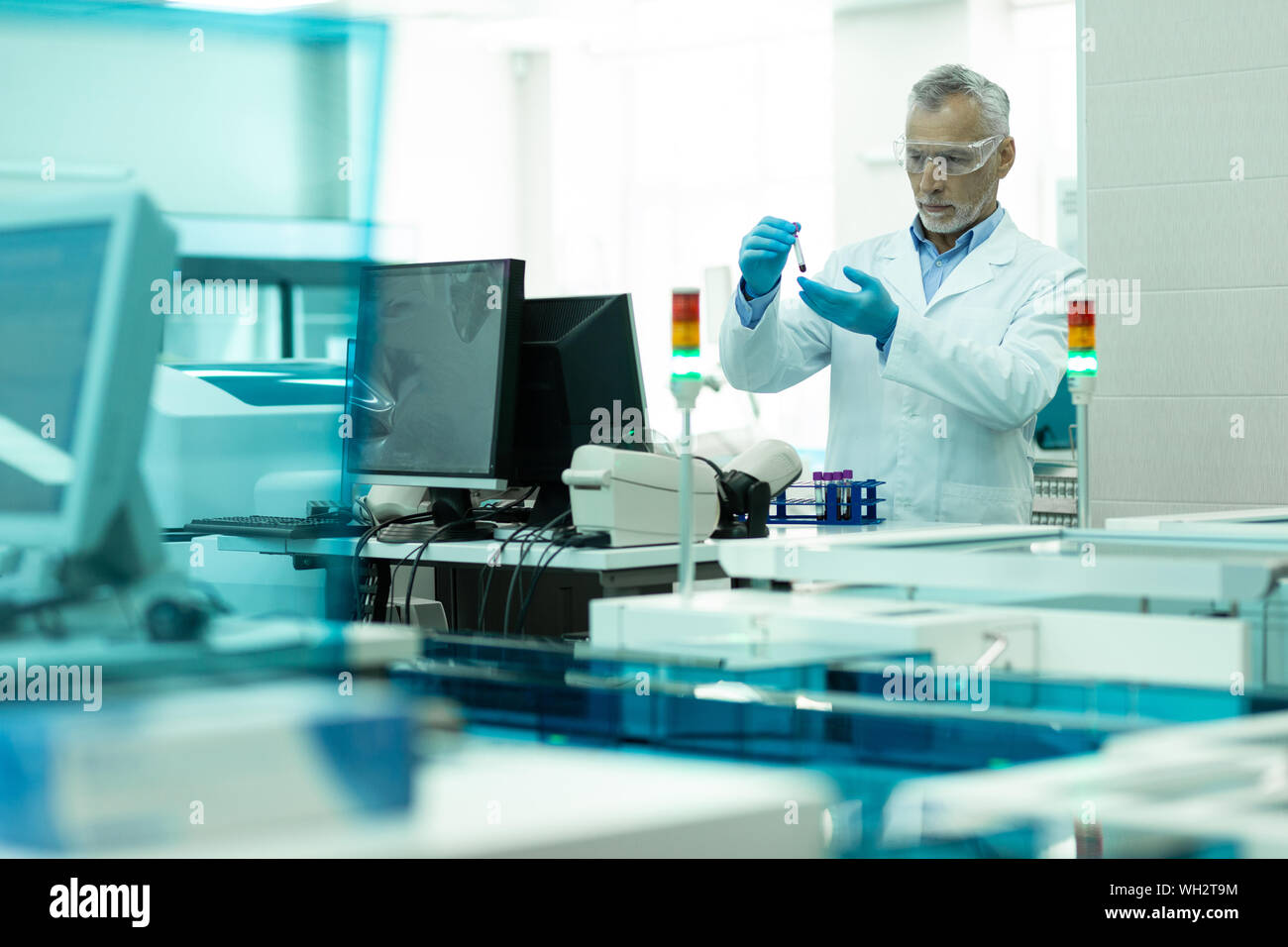 Concentrated senior male person working in laboratory Stock Photo - Alamy