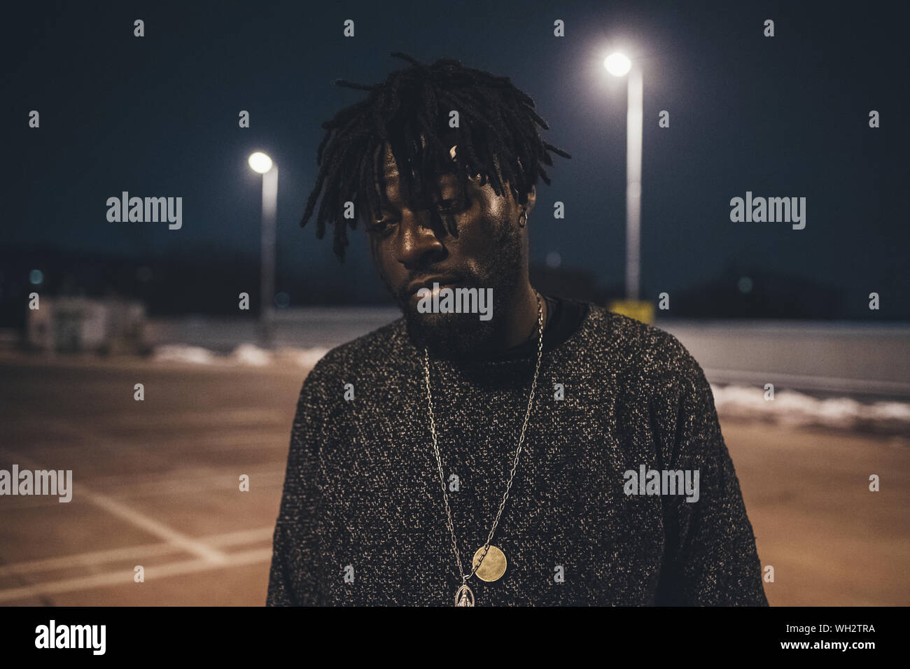 portrait of young african man posing in parking space– self control ...