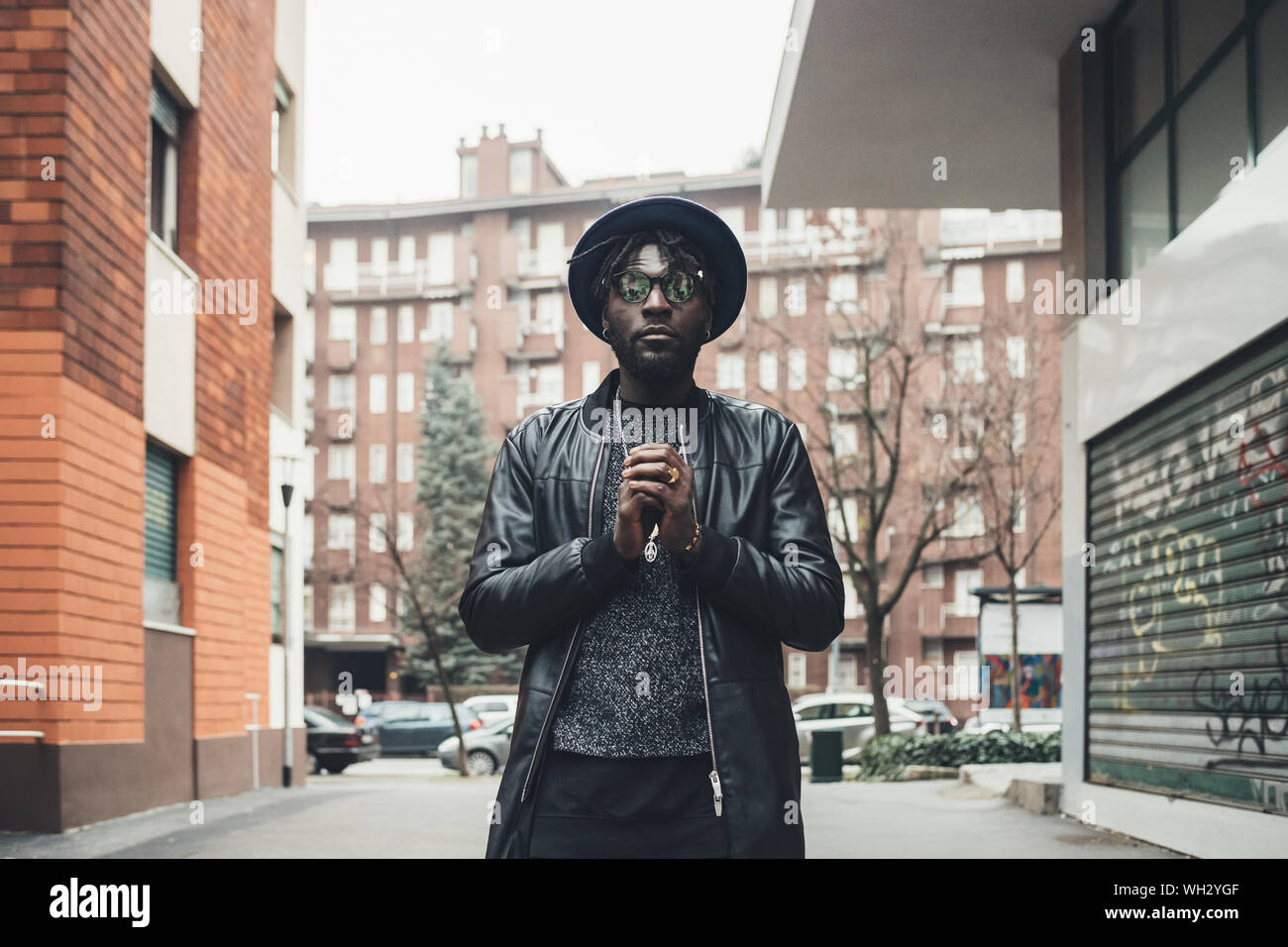 portrait of young black man in urban background – calm, youth, natural ...