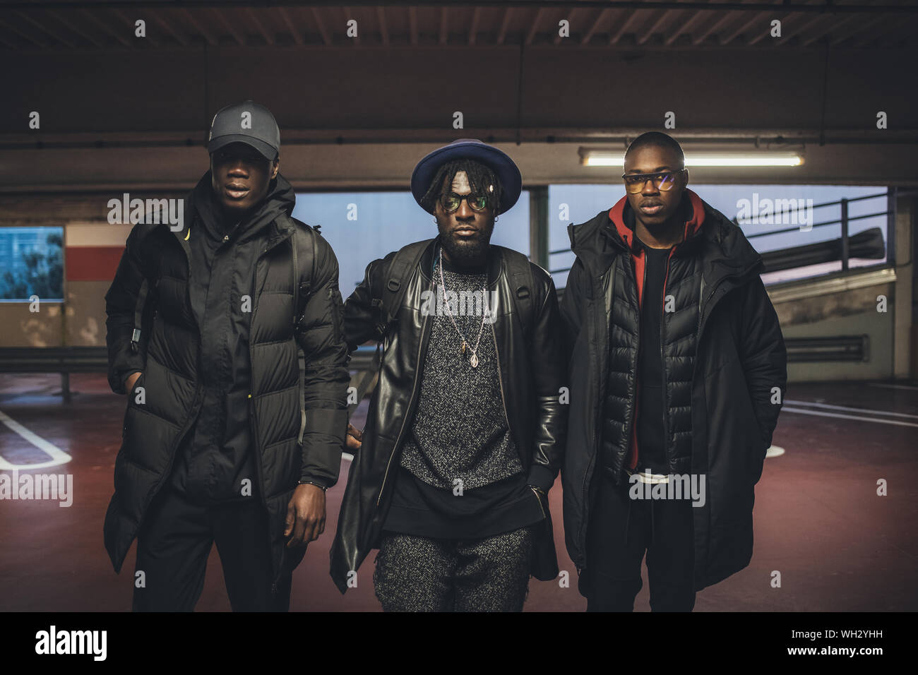 three young black men posing in a parking lot looking away - swag, crew ...