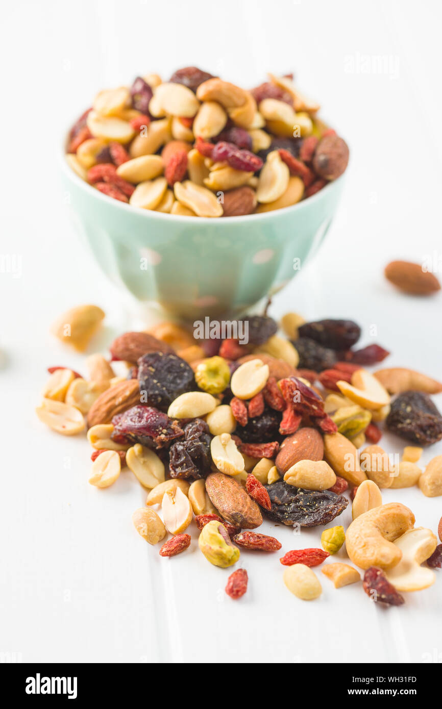 Mix of various nuts and raisins on white table Stock Photo - Alamy