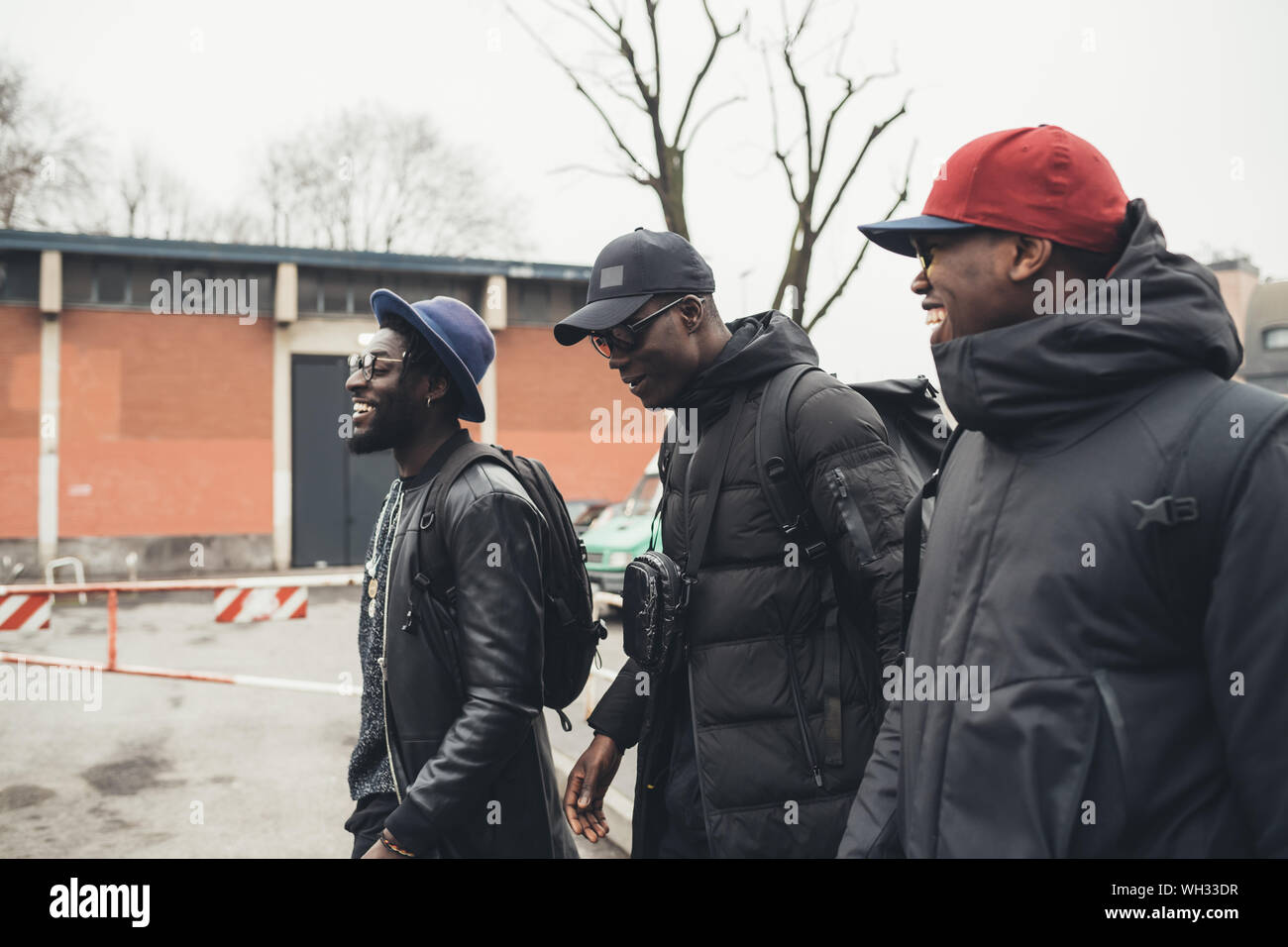 three young african men walking in the street together – relationship ...