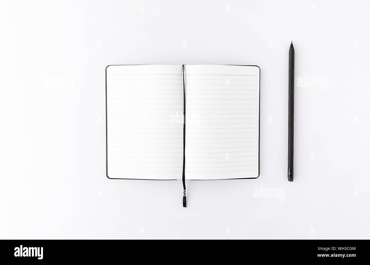 Top view of opened notepad with black pencil white background. Mockup ...