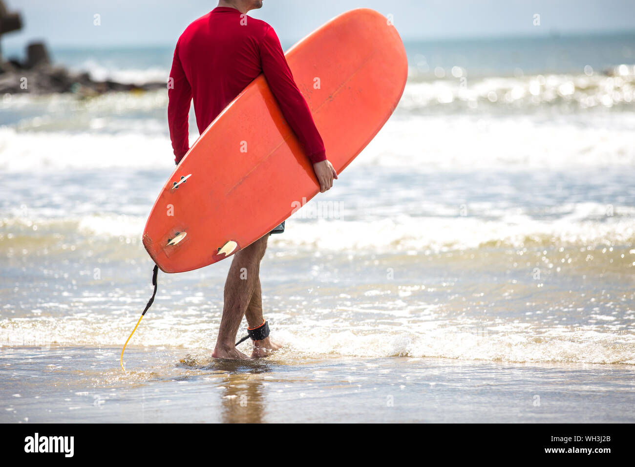 Surfer on beach hi-res stock photography and images - Alamy