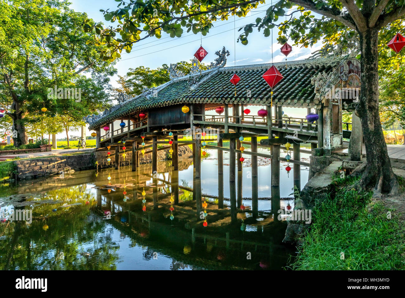 Thanh Toan tile bridge. Old wooden bridge crosses the river branch ...