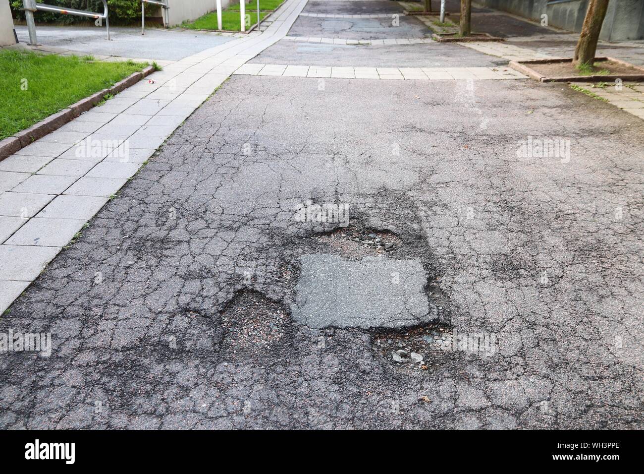 Damaged local street in Gothenburg, Sweden. Road maintenance concept ...