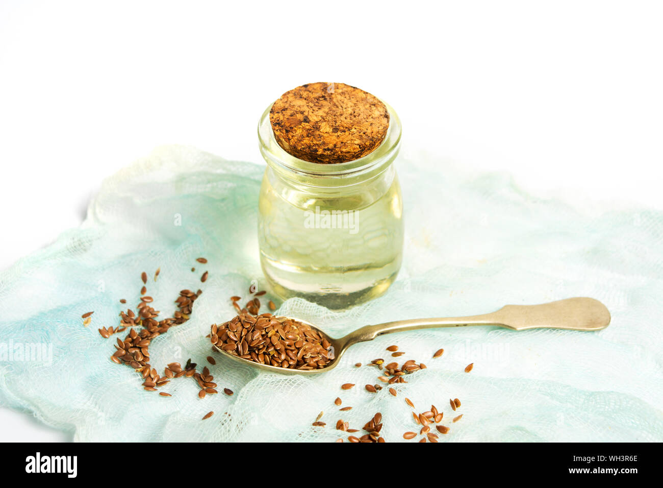 Linen flax seeds essential oil in a bottle Stock Photo - Alamy
