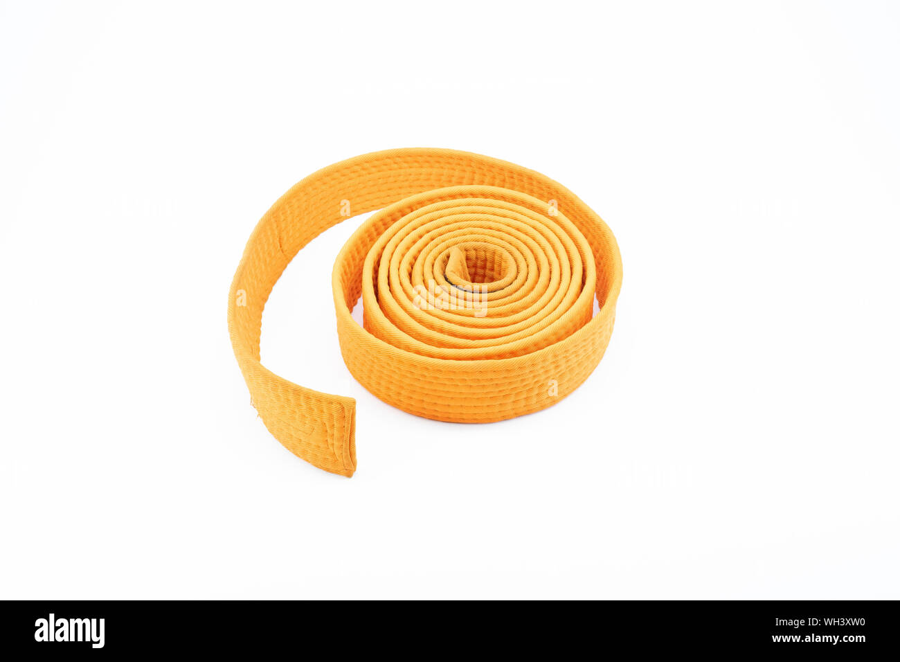 Orange karate belt on white background Stock Photo - Alamy