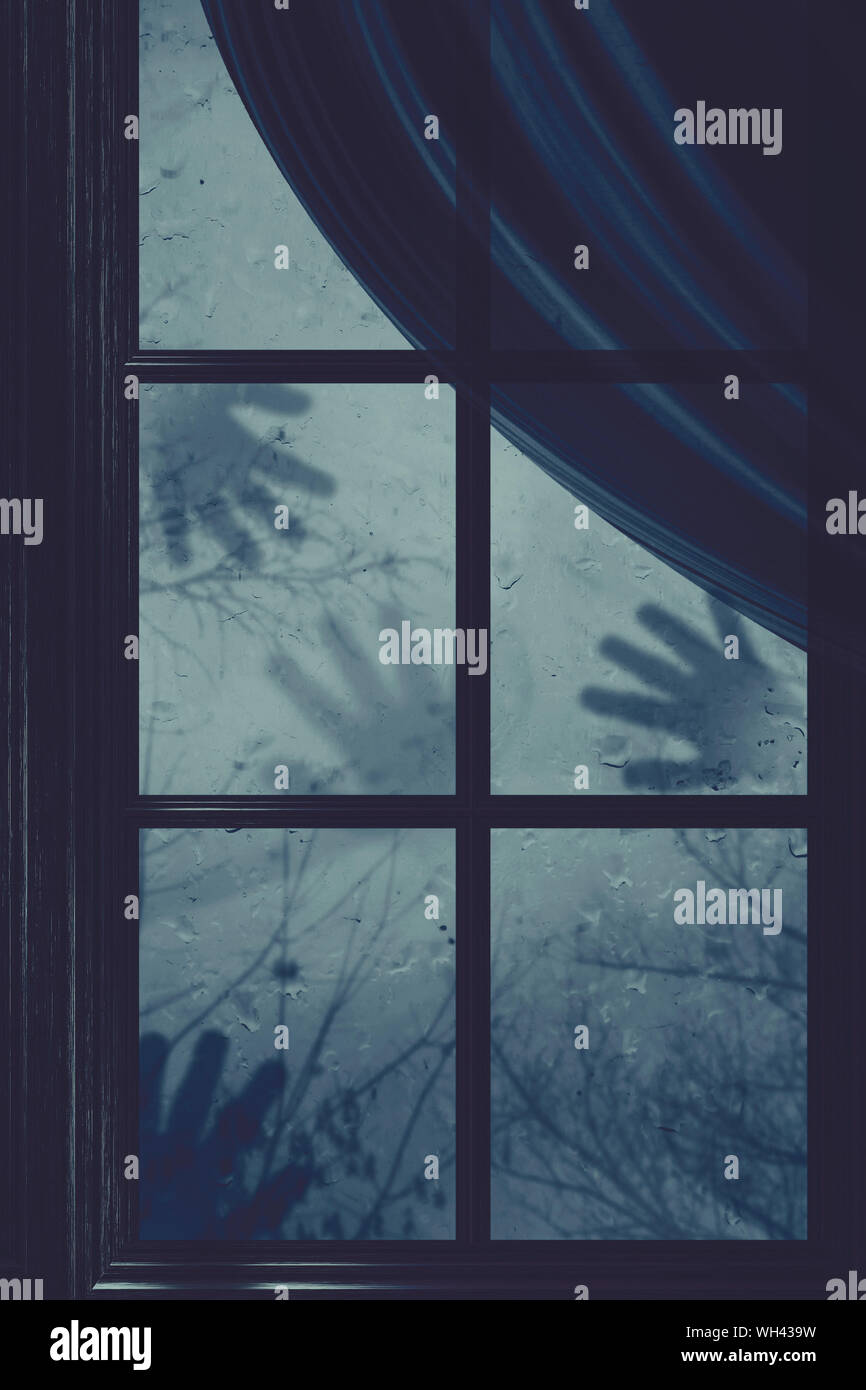 Grunge wooden window with water drops on glass and human hand shape ...