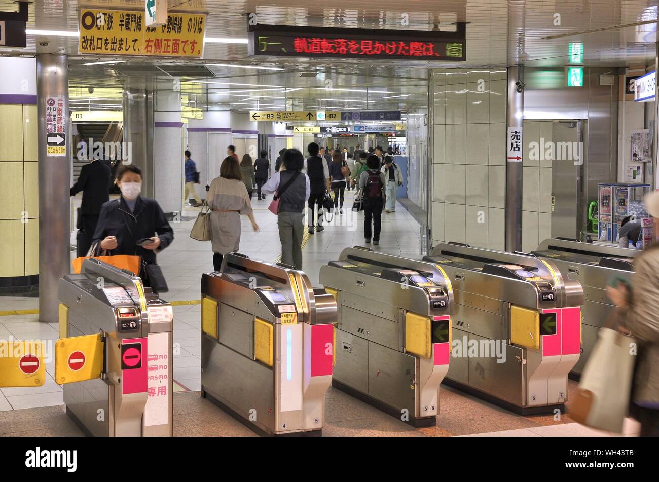 TOKYO, JAPAN - APRIL 13, 2012: People enter Toei Metro in Tokyo. With ...