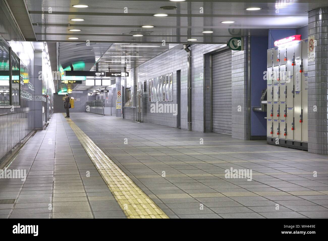 OSAKA, JAPAN - APRIL 25, 2012: People wait at Osaka Subway station in ...