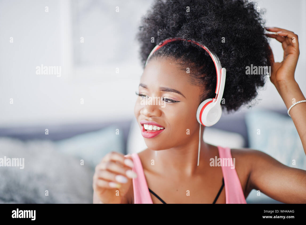 Young african american woman listen music on earphones Stock Photo - Alamy
