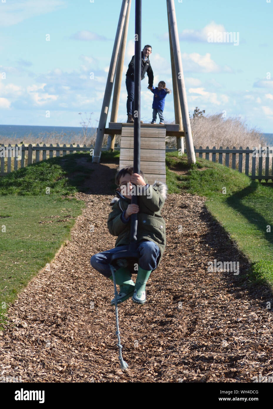 Two boys playing rope swing hi-res stock photography and images - Alamy