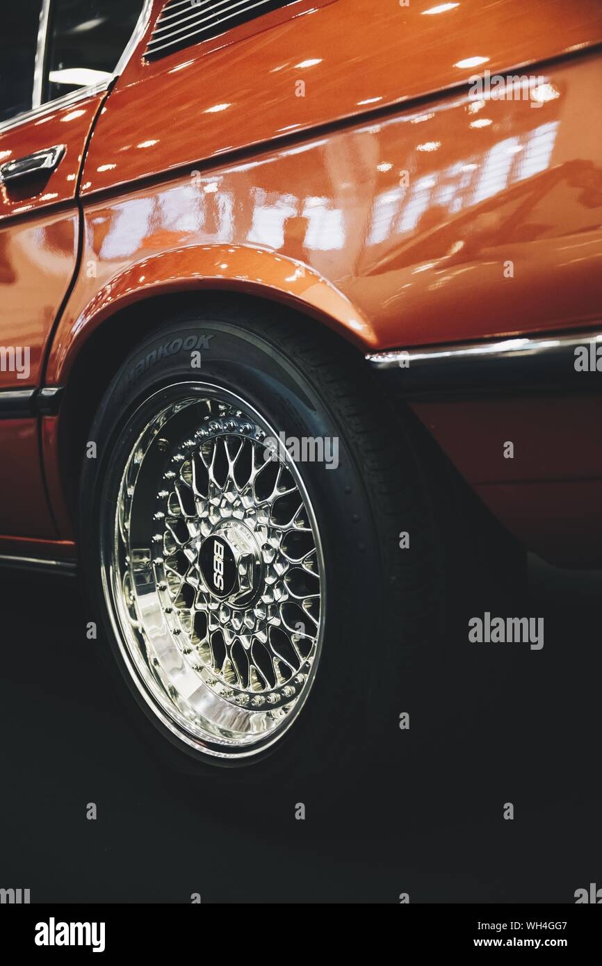 Vertical shot of an old red car with shiny rims Stock Photo - Alamy