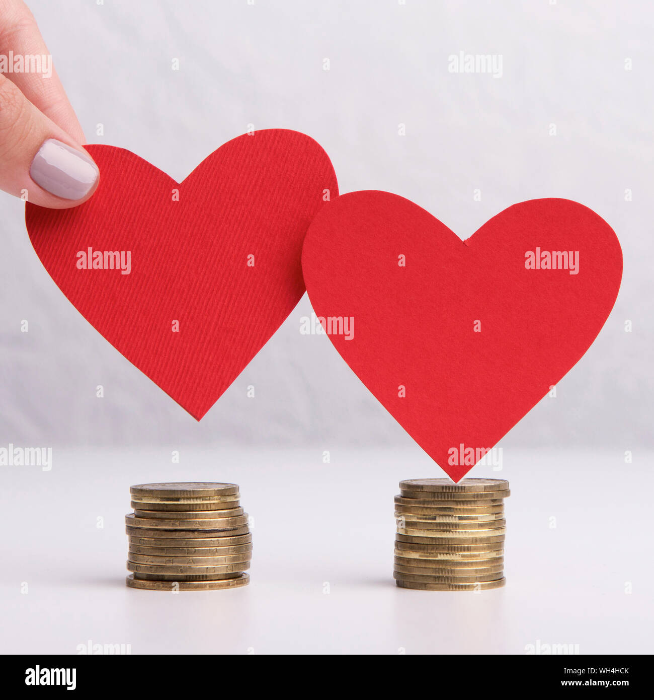 Hand holding heart coins hi-res stock photography and images - Alamy