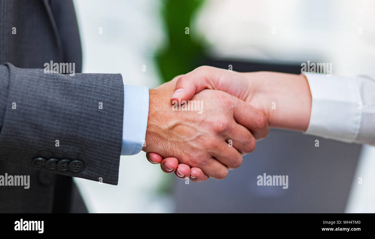 Businessmen shaking hands to seal a deal Stock Photo - Alamy