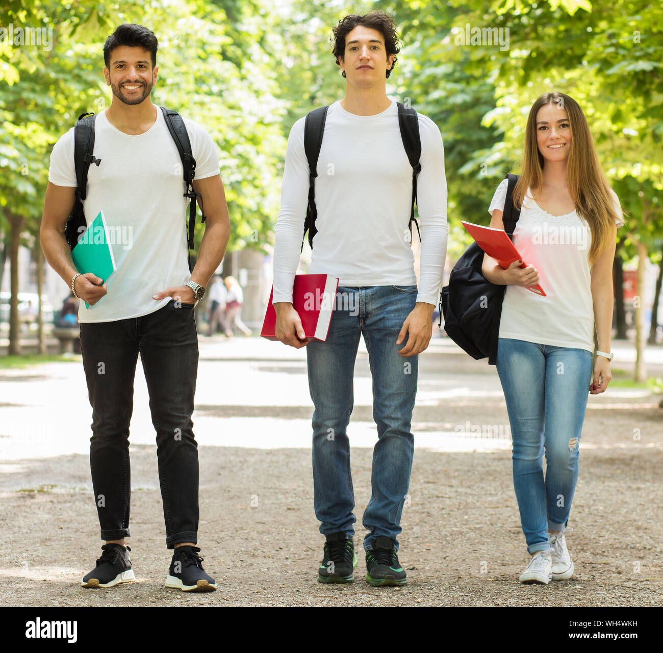 Happy students outdoor smiling Stock Photo - Alamy