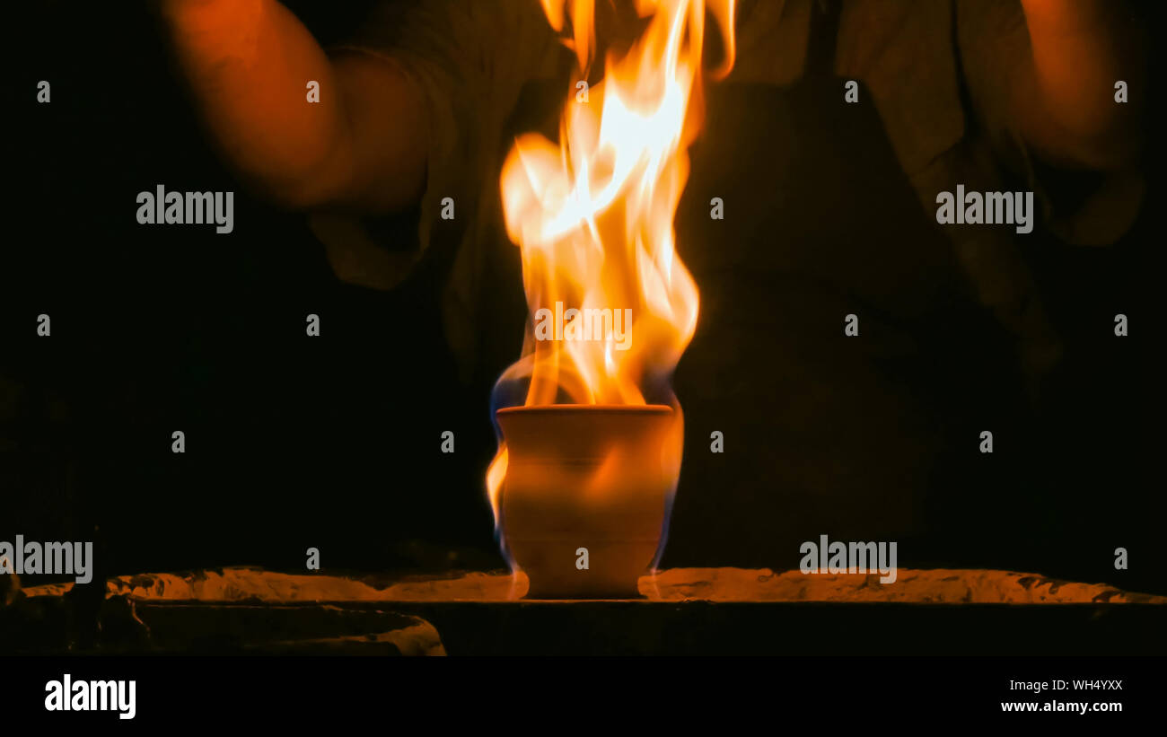 Burning ceramic mug on pottery wheel Stock Photo - Alamy