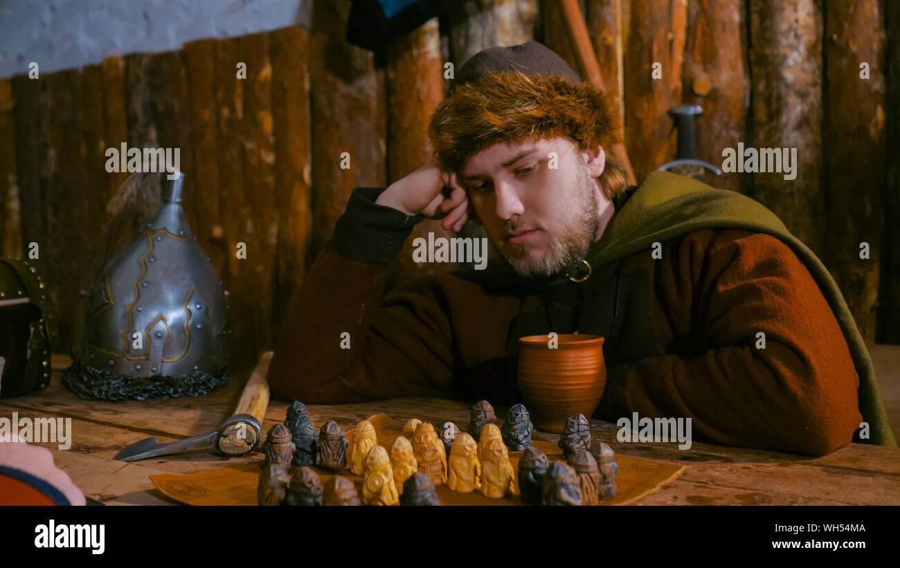 Portrait of man in russian ethnic suit playing chess Stock Photo - Alamy