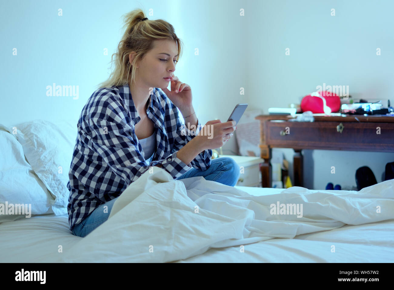Sad female teenager texting hi-res stock photography and images - Alamy