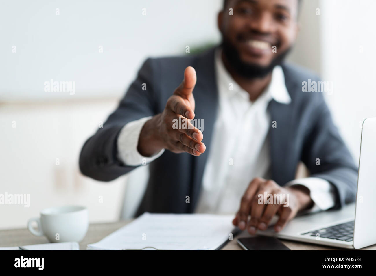 Businessman extending hand handshake hi-res stock photography and ...
