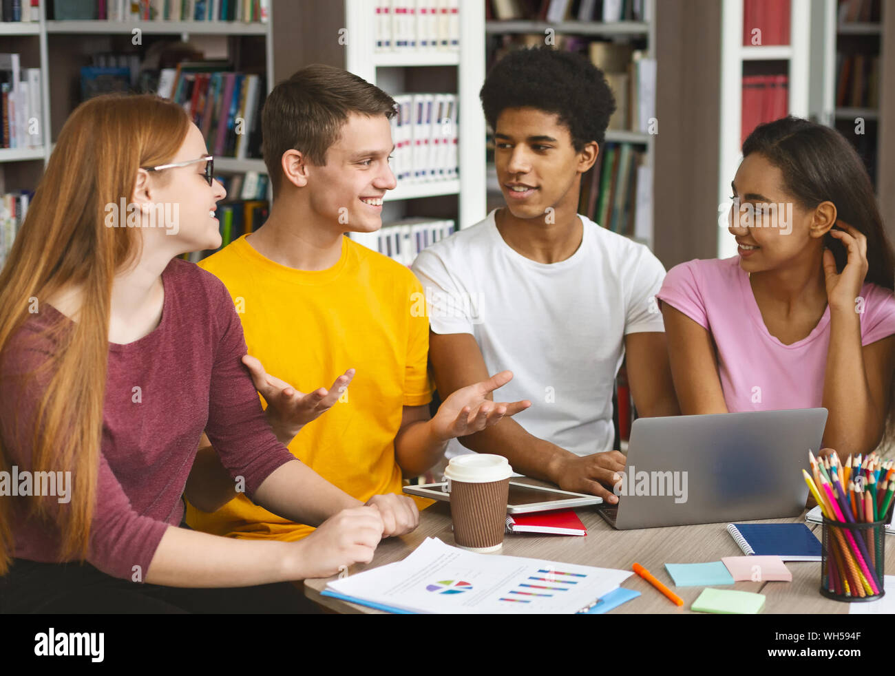 Young college students studying together at library Stock Photo - Alamy