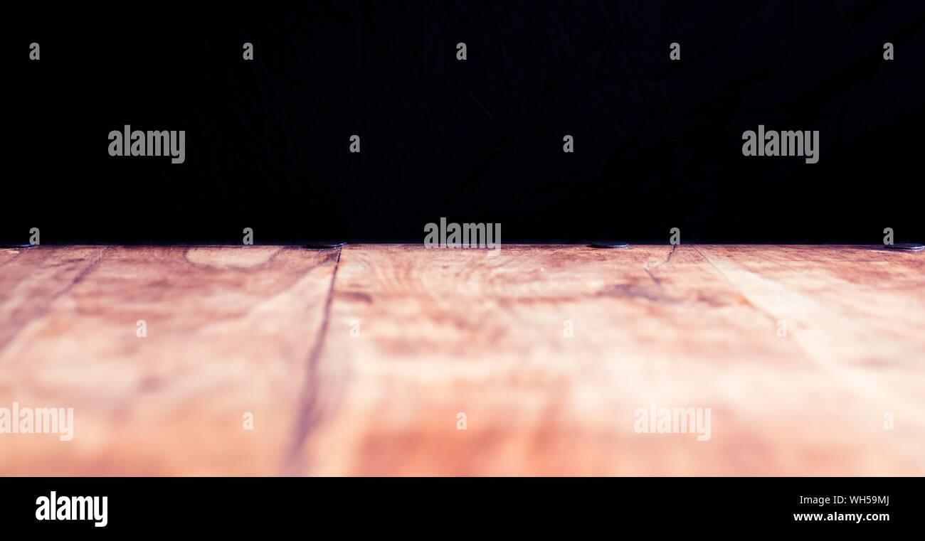 Rustic wooden table and dark background Stock Photo - Alamy