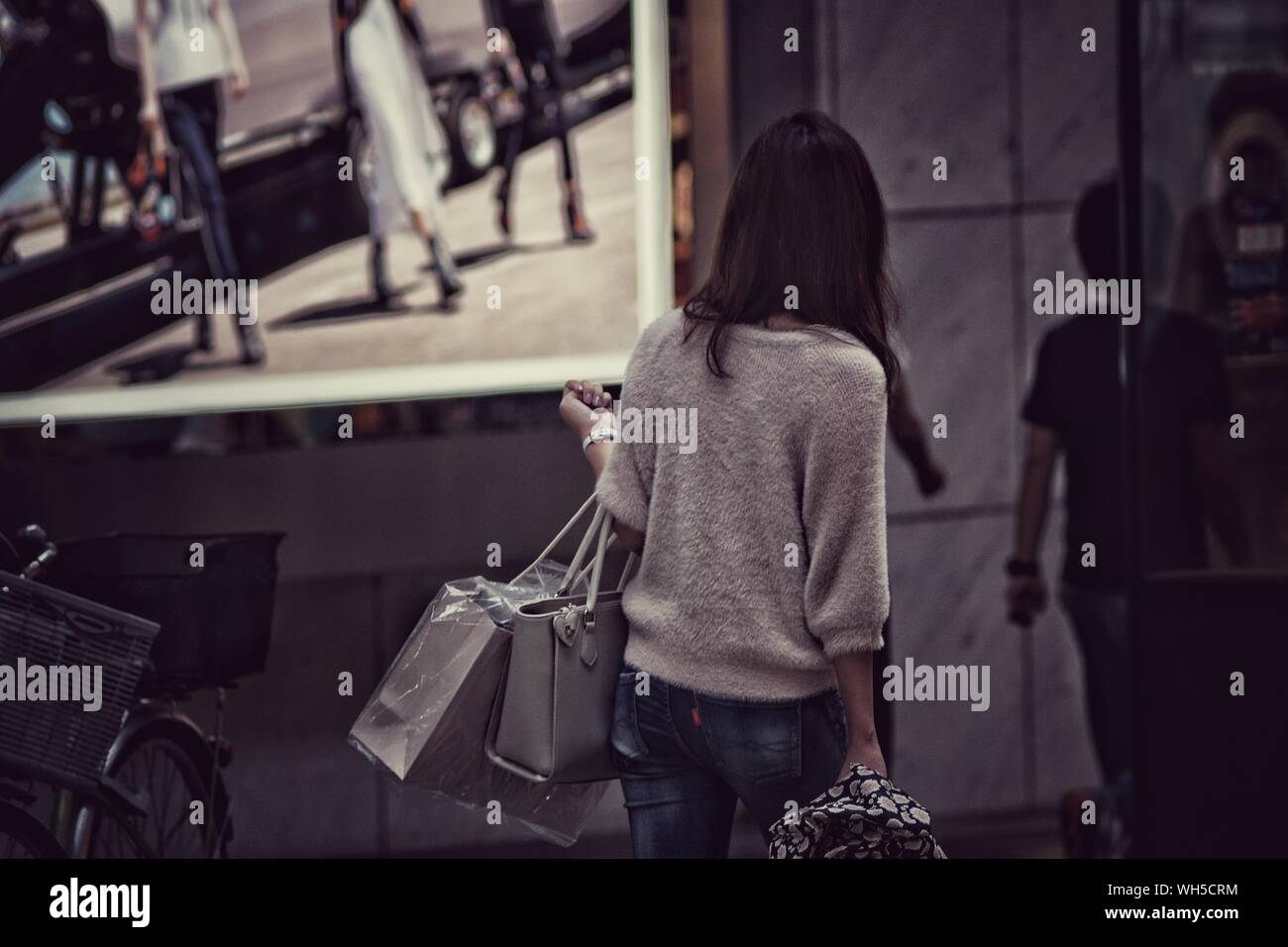 Walking carrying bags hi-res stock photography and images - Alamy
