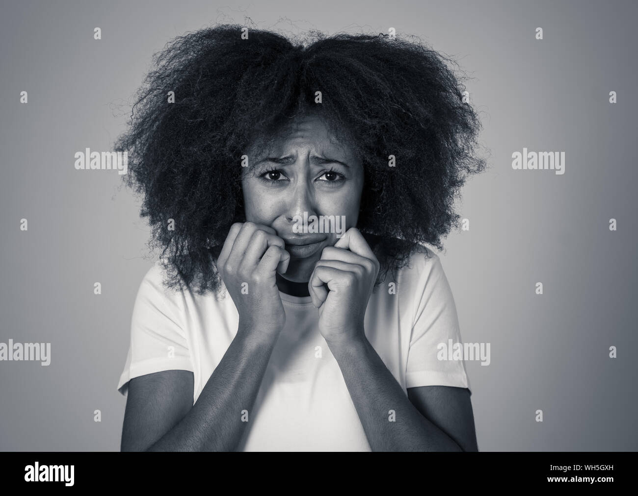 Portrait of young african american woman feeling scared and shocked ...