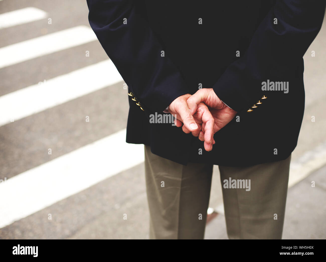 Hands clasped behind back hi-res stock photography and images - Alamy