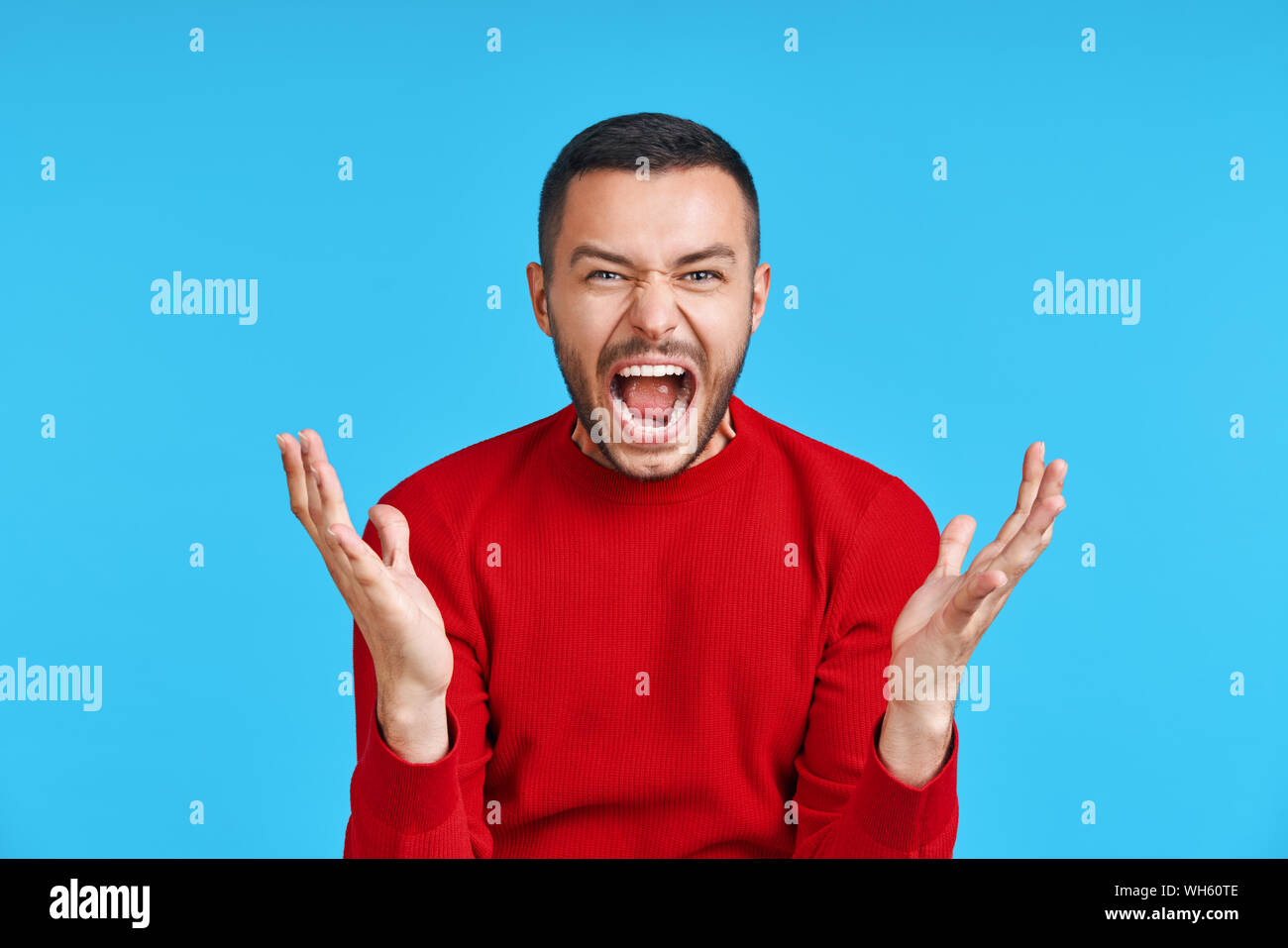 Screaming angry man on blue background. stress emotions concept Stock ...