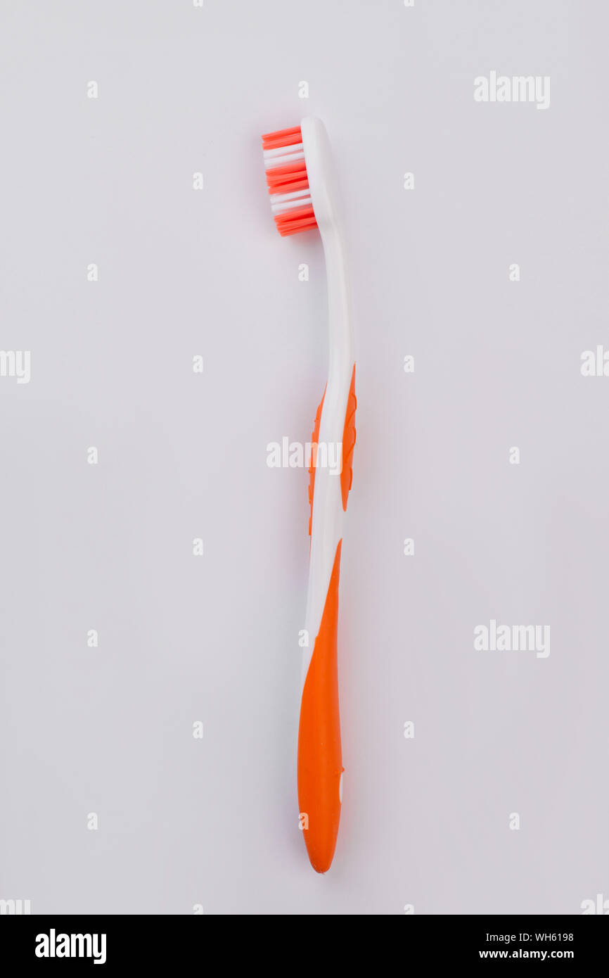Orange toothbrush isolated on white background Stock Photo - Alamy