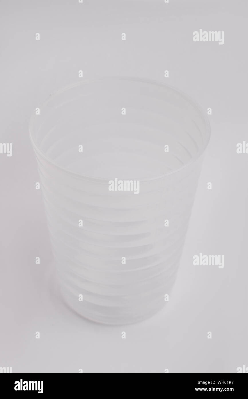 Transparent plastic glass on white background Stock Photo - Alamy