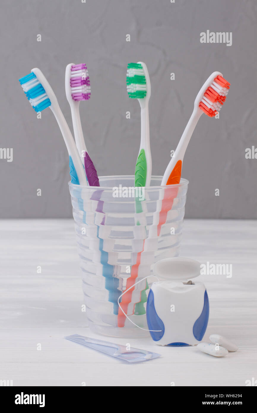 Toothbrush in glass, dental floss and chewing gums Stock Photo - Alamy