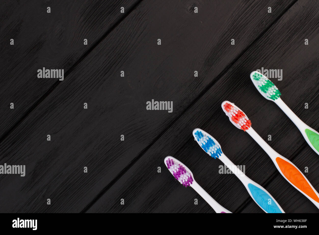 Colorful toothbrushes on black hi-res stock photography and images - Alamy