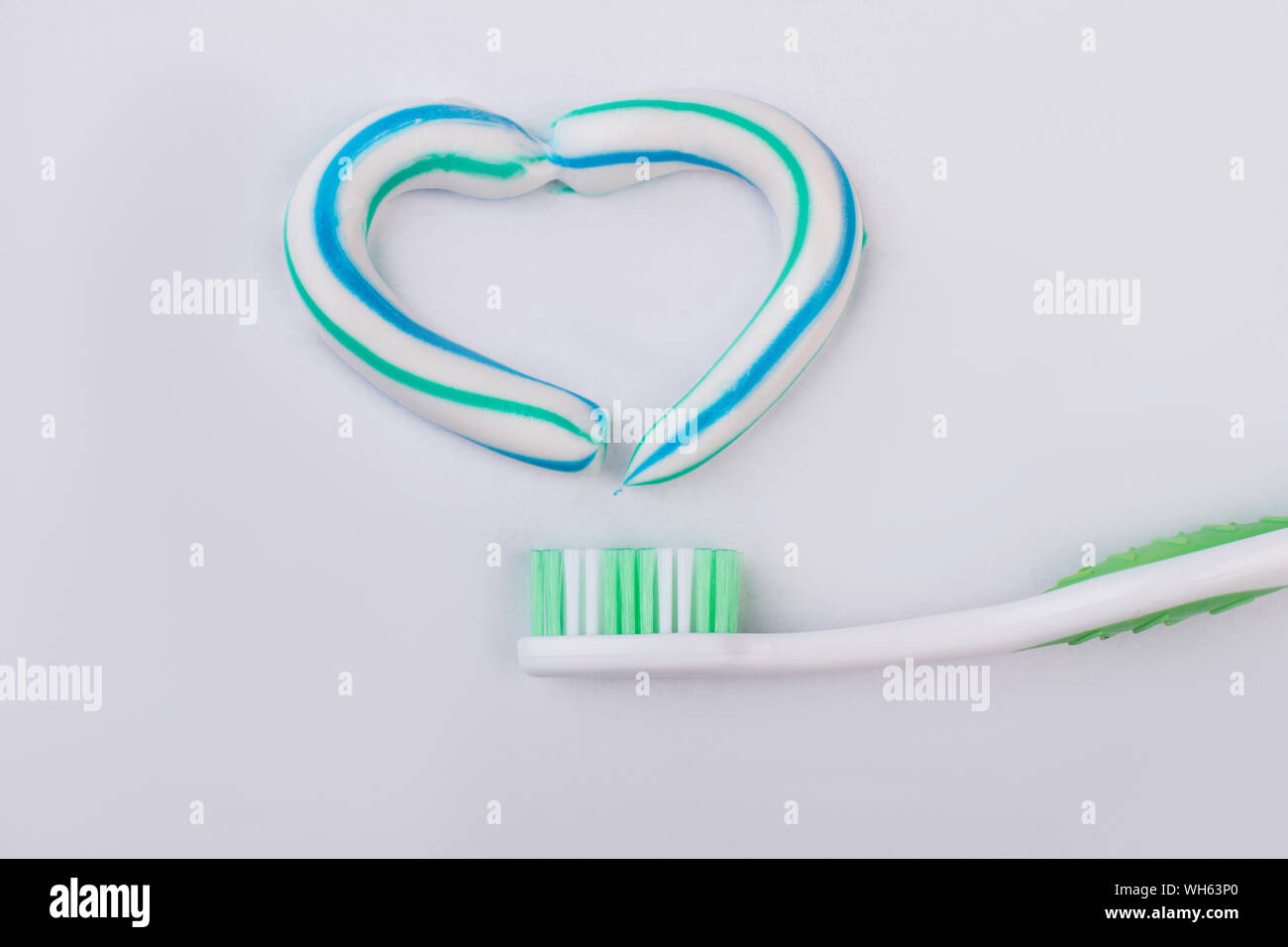 Toothbrush and heart made from a toothpaste Stock Photo - Alamy