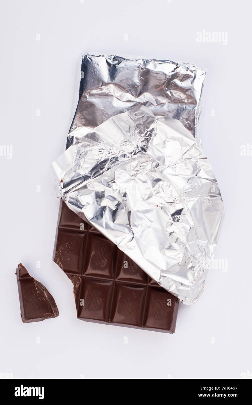 Dark chocolate wrapped in foil, top view Stock Photo - Alamy