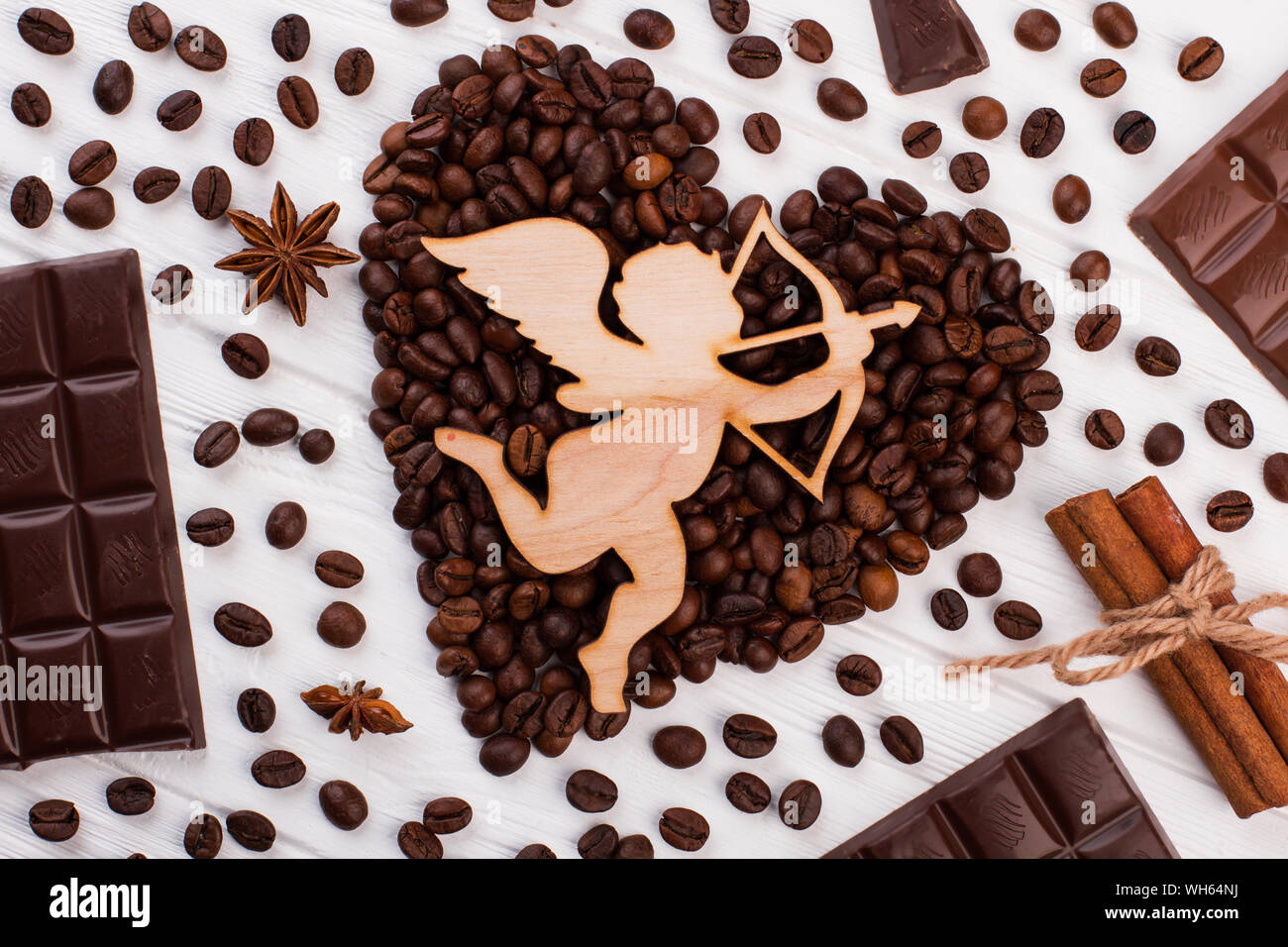 Heart shaped coffee beans and cupid with arrow Stock Photo - Alamy