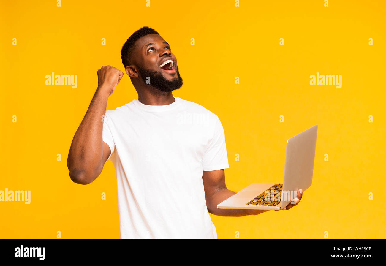 Excited african man celebrating hi-res stock photography and images - Alamy
