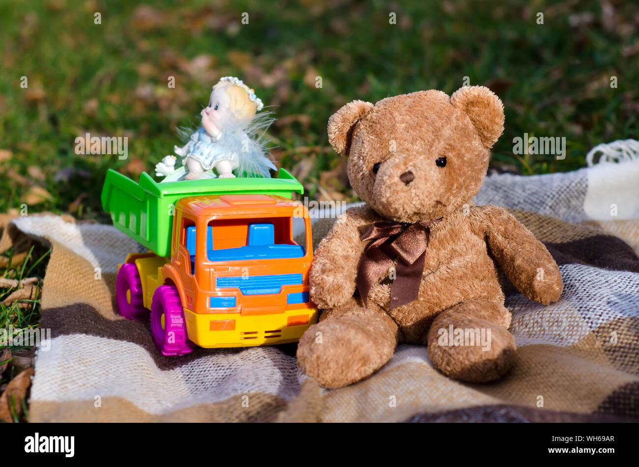 Toy brown Teddy bear and colorful toy car truck Stock Photo - Alamy