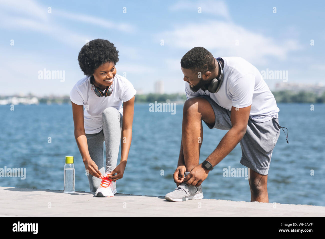 Afro Couple Lacing Shoes Preparing For Morning Jog Outside Stock Photo ...