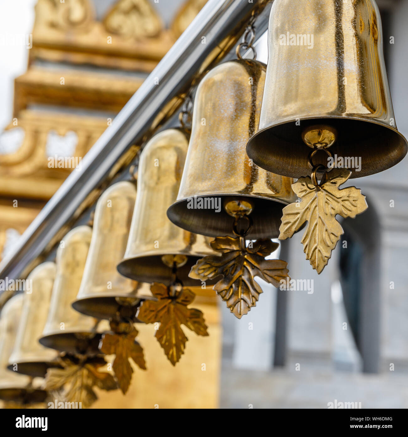 Golden bells at Buddhist temple Wat Traimit, Bangkok, Thailand. Square ...