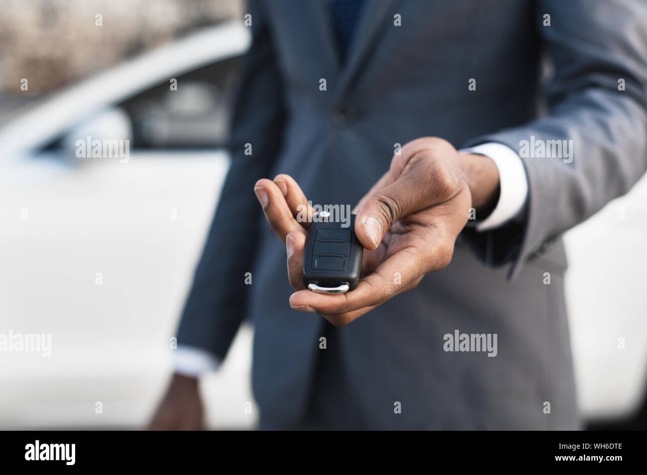 Car sale concept. Man hand giving car key Stock Photo - Alamy