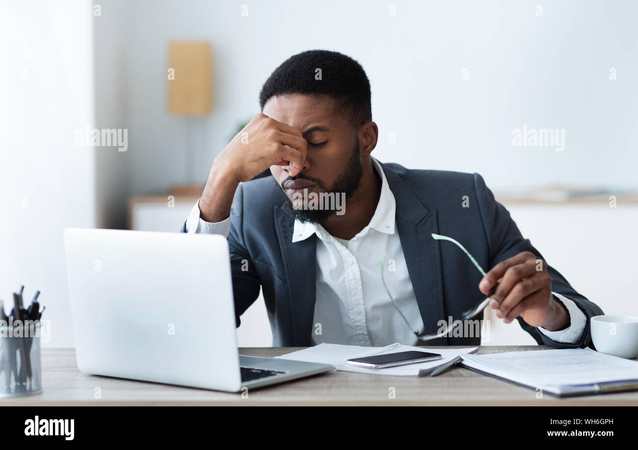 African american businessman tired of long time work on laptop Stock ...