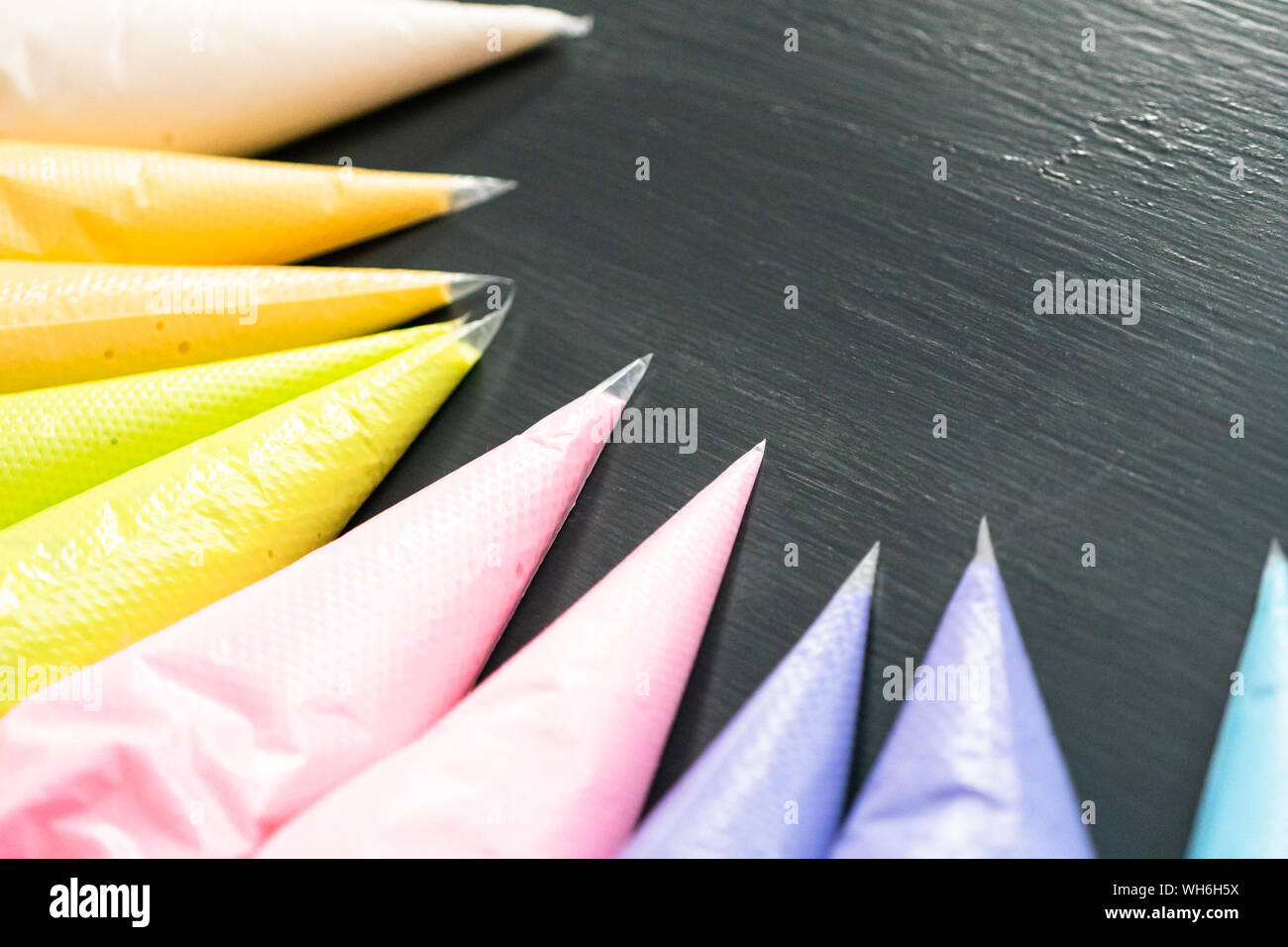 Variety of colors of royal icing in plastic piping bags Stock Photo - Alamy
