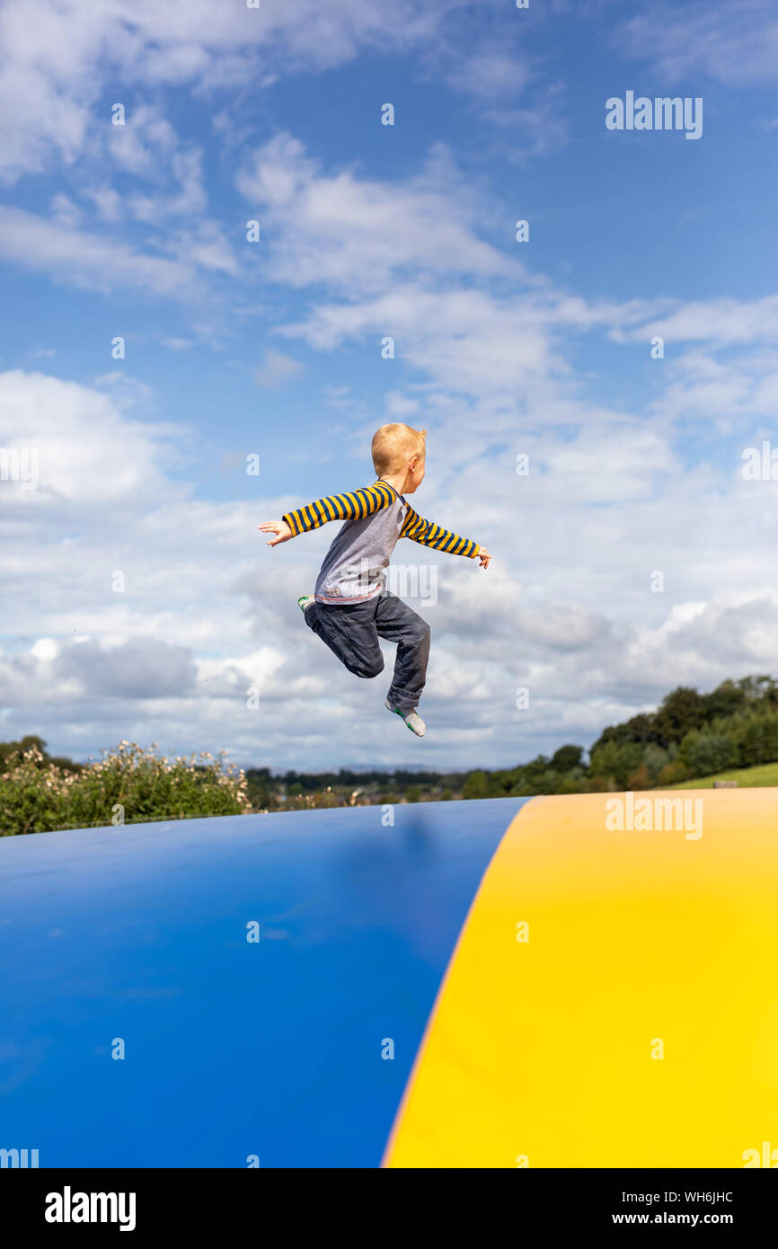 young boy jumping on trampoline Stock Photo - Alamy