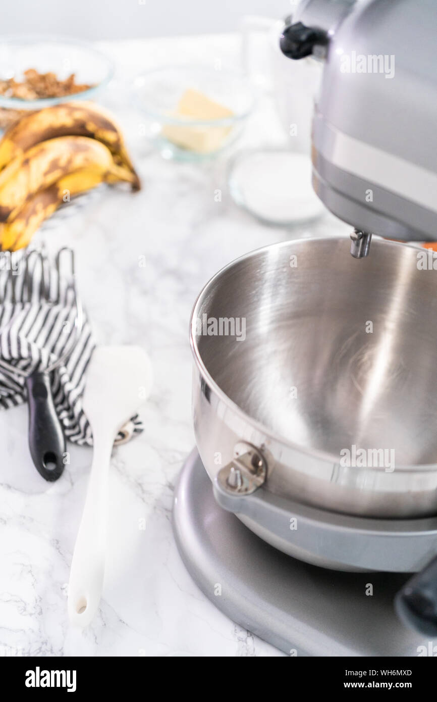 Mixing ingredients in kitchen mixer to bake banana nut bread Stock ...