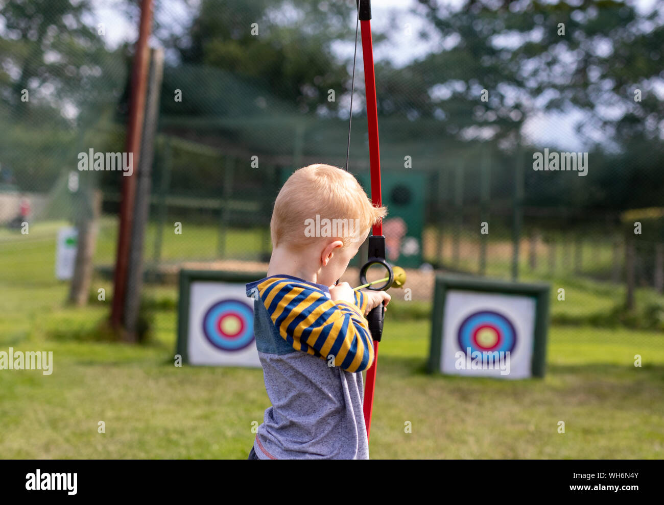 young boy aiming archery bow Stock Photo - Alamy