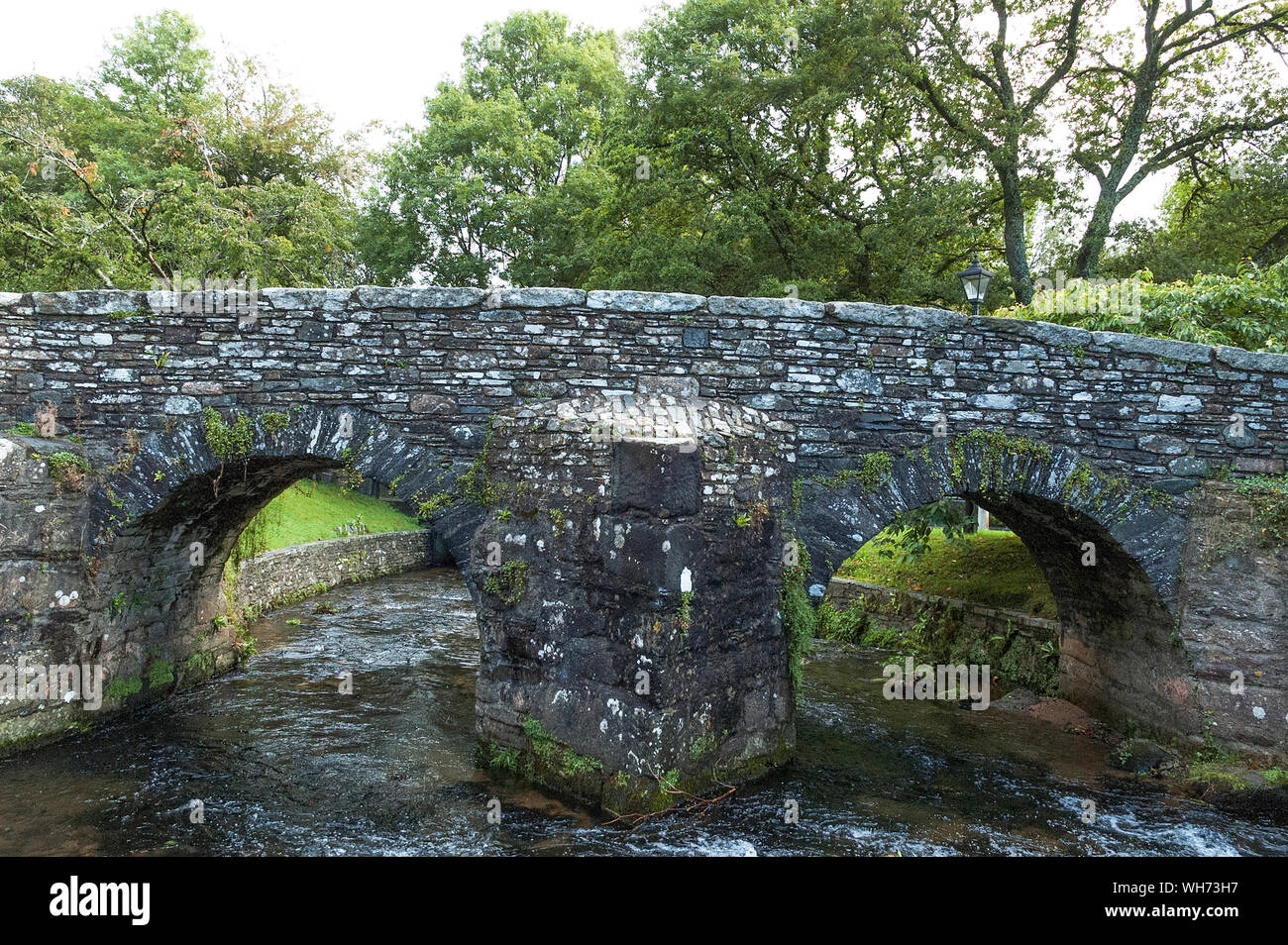 the river inney runs under 15th century packhorse bridge at altarnun in ...